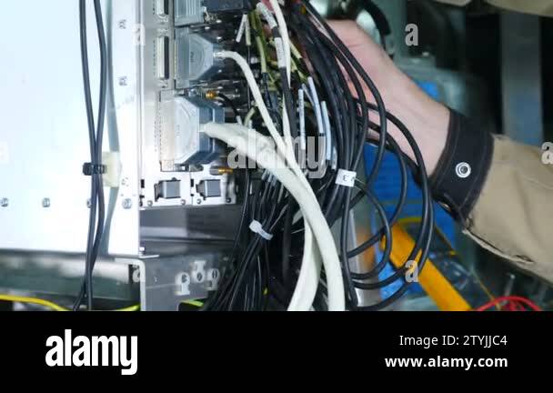 Electronic device assembly or repairing. A male service worker installs ...