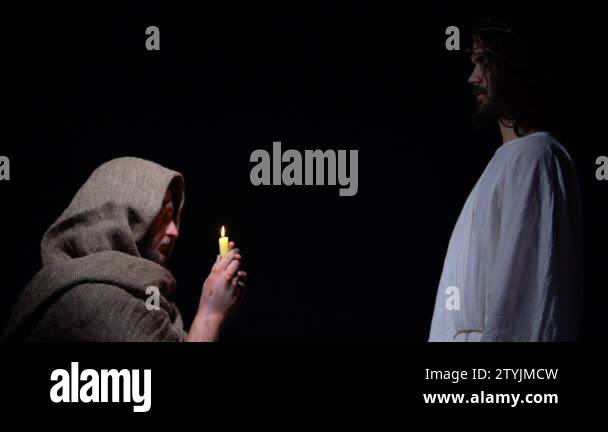Poor man holding candle and praying Jesus in crown of thorns belief in ...