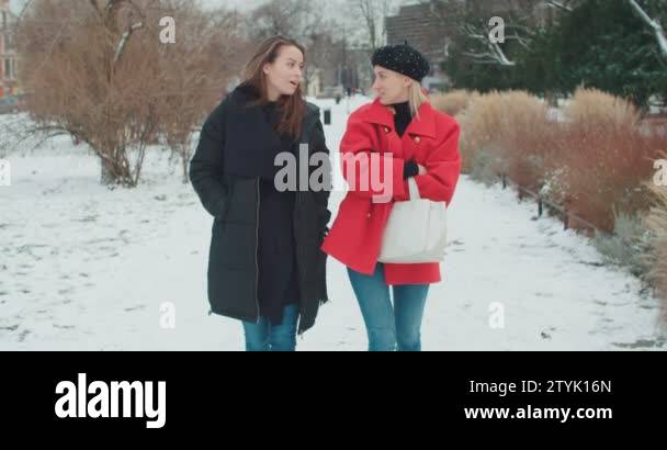 Two young girls in a city enjoying time. Positive face expressions ...