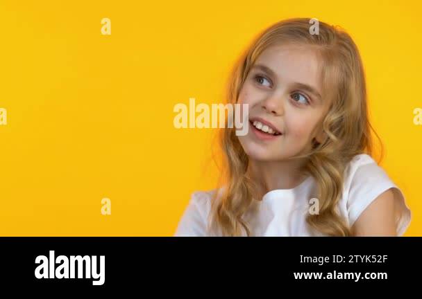 Little girl looking at empty background and showing thumbs-up, children ...