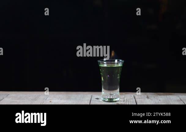 Beautiful slow motion shot of barista making cocktail in a bar. Flames ...