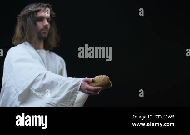 Jesus giving bread to poor man on black background, biblical history ...