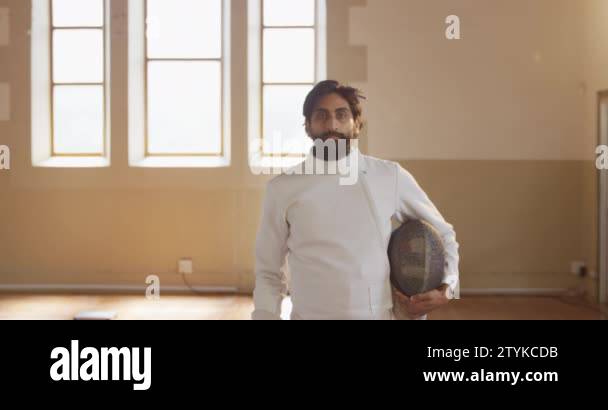Portrait of a confident focused mixed race male fencer athlete during a ...