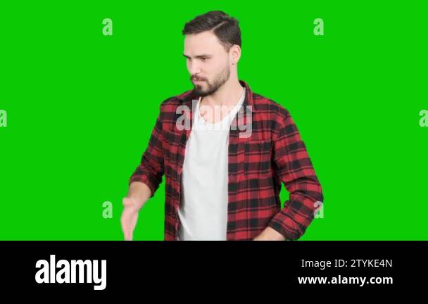 Young man dancing with green screen in background. White male with ...