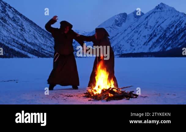 Two monks in brown cloaks of the order of St. Francis are fighting near ...