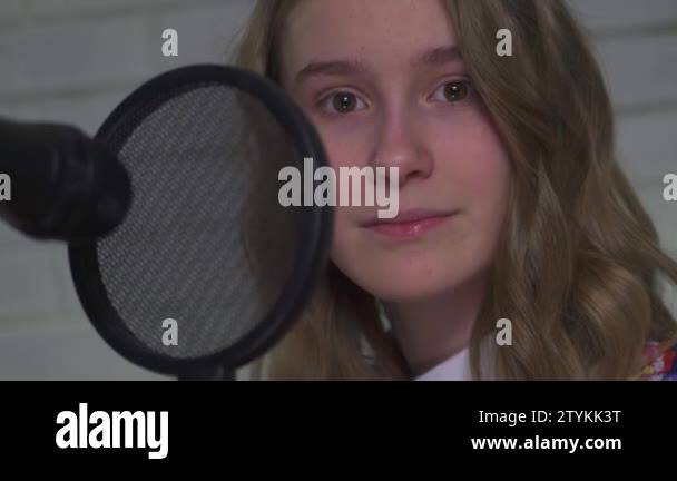 Singer teenager girl is training to make music in track recording ...