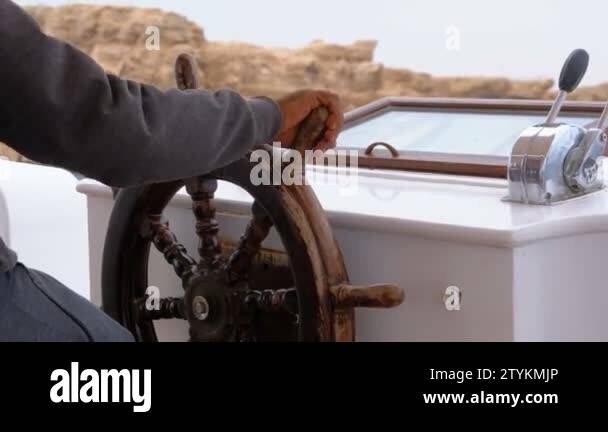 Captain at the Steering Wheel of a pleasure boat. Captain controls the ...