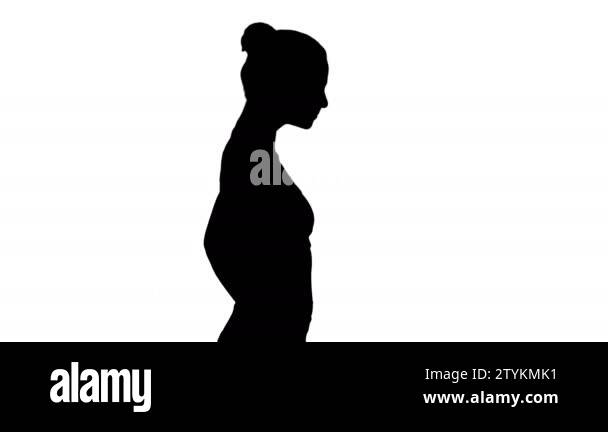 Silhouette Female walking and doing neck stretching exercise to release ...