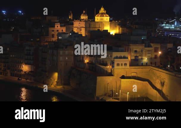 Panoramic night view of a coast line and the downtown of Valletta ...
