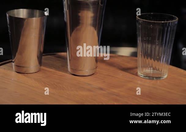 Cocktail shaker and beaker for preparation beverages on bar counter in ...