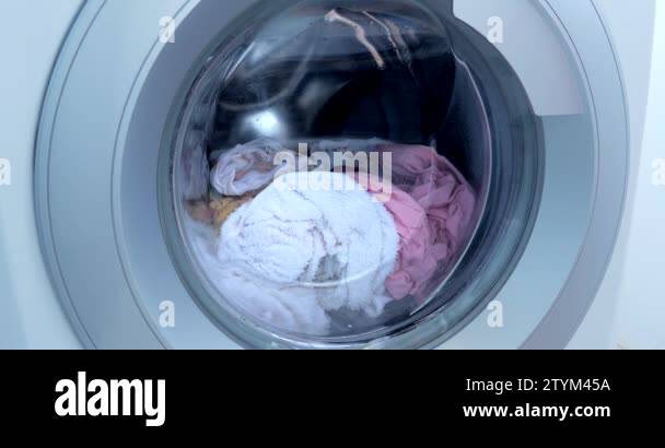 Loading the washing machine. Industrial Washing Machine Washes Colored ...