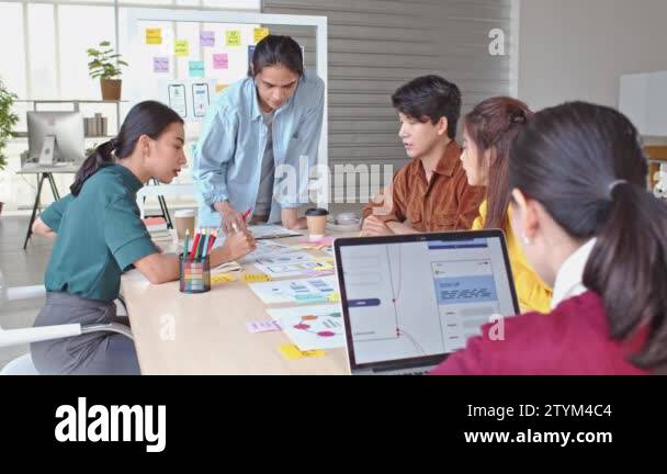Young Asian business creative team work together, mobile application ...