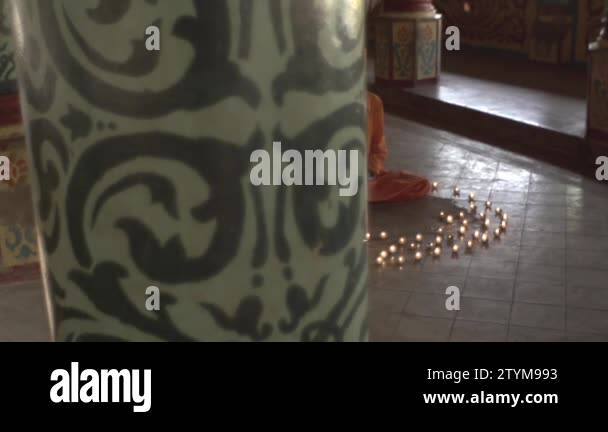 A monk in an ancient temple lights a sacred fire, the priestess brought ...