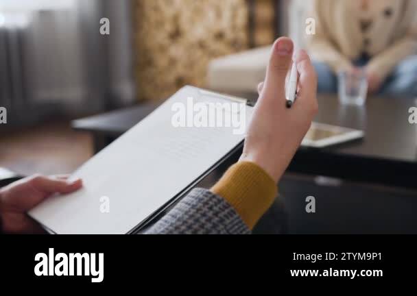 Front view of elegant mans hand which holding the folder with notes and ...