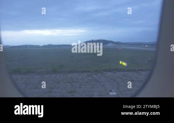 View from airplane window driving on runway while taking off in airport ...