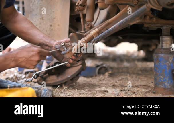 Hands of mechanical using fix wrench tool to spinning bolt of the truck ...