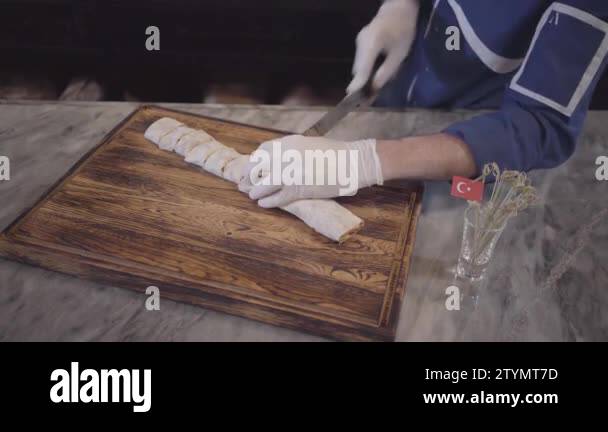 Skillful man in blue chef uniform cooking kebab in modern turkish ...