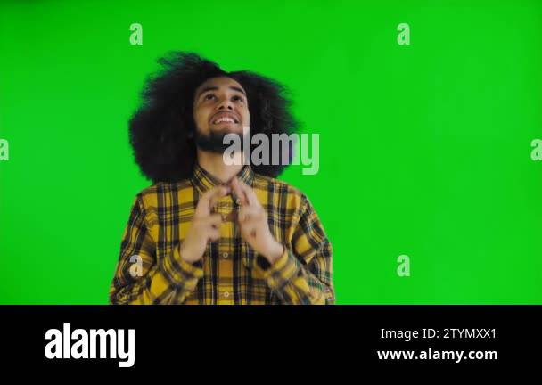 Portrait of praying african american guy keeping fingers crossed and ...