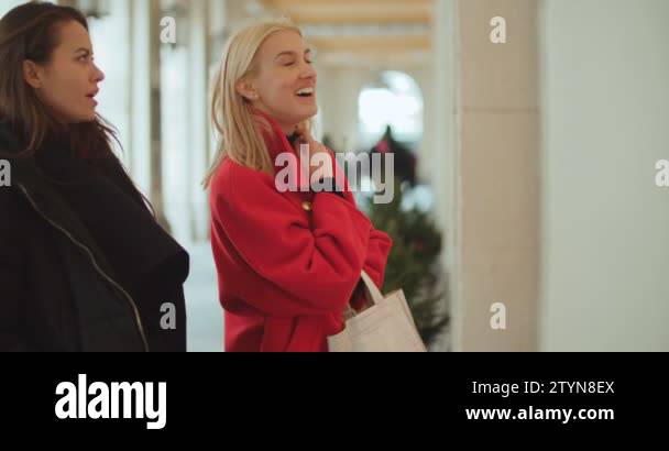 Two young girls in a city enjoying time. Positive face expressions ...