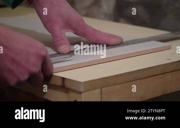 Worker with a hand cutter cuts tile. Finishing works, focus on hands ...