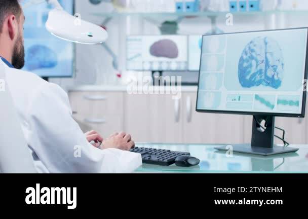 Researcher in medicine field typing in computer keyboard, looking at X ...