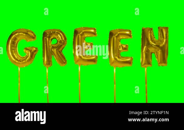Word green from helium golden balloon letters floating on green screen ...