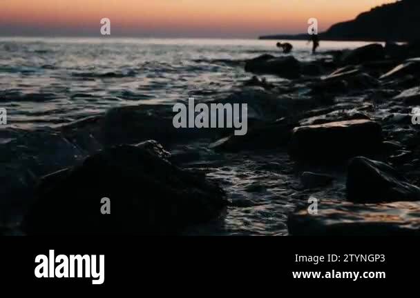 Red sunsets over sea . The sun touches horizon. Red sky, yellow sun and amazing sea. Summer ...