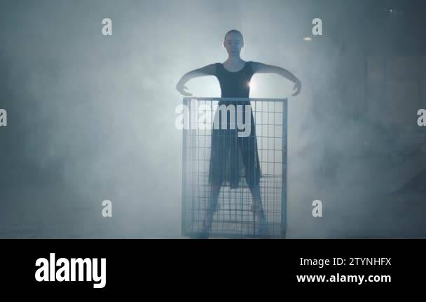 Professional ballerina dancing in black dress in the studio in big blue ...