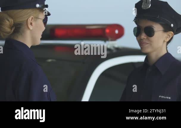 Police lady making high-five gesture trustful relations in squad gender ...