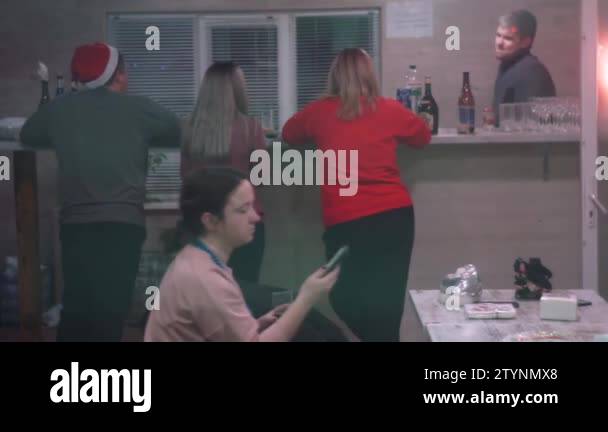 Back view of four young men drinking beer and talking while sitting at ...