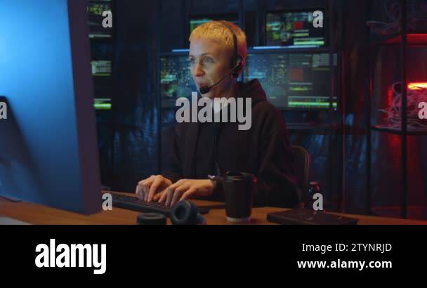 Caucasian female professional IT worker in headset typing on keyboard ...