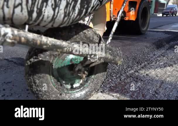 Steamroller and Road Construction Workers at Road Construction Site ...