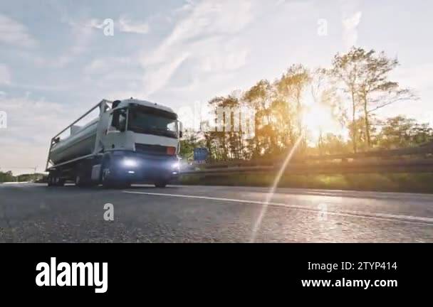 Cargo truck with fuel diesel cargo trailer driving on a highway. White ...