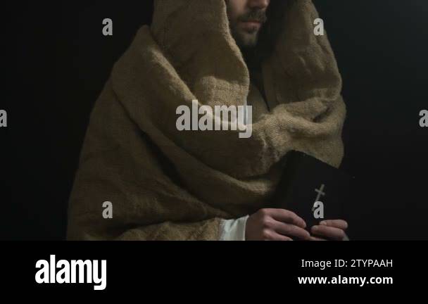 Jesus Christ showing holy bible to camera, God canons, religious life ...