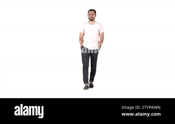 Confident young adult man walking forwards and looking at camera in ... Confident young adult man walking forwards and looking at camera in ...