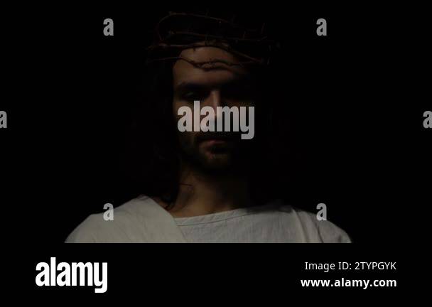 Crying Jesus in crown of thorns raising hands to sky, talking with God ...