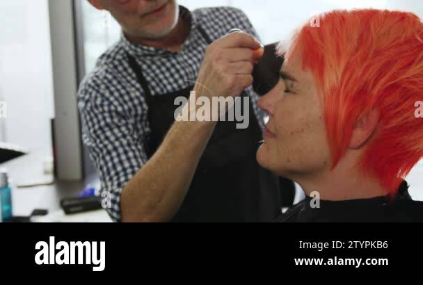 Alternative cool hair salon. Side view of a Caucasian male hairdresser ...