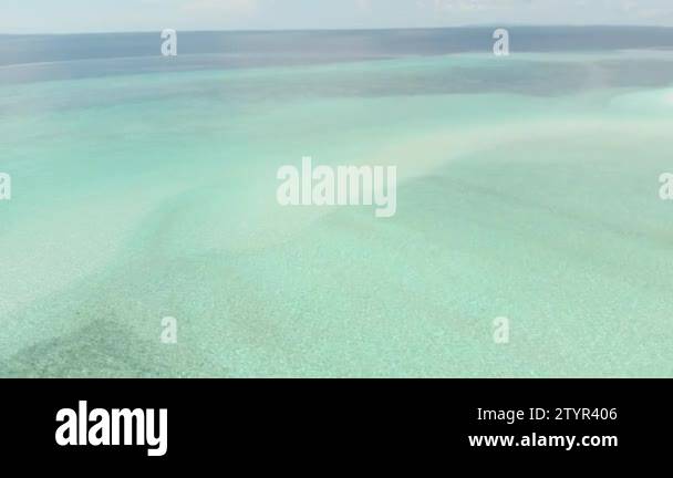Aerial: Flying over idyllic atoll, travel destination Wakatobi National ...