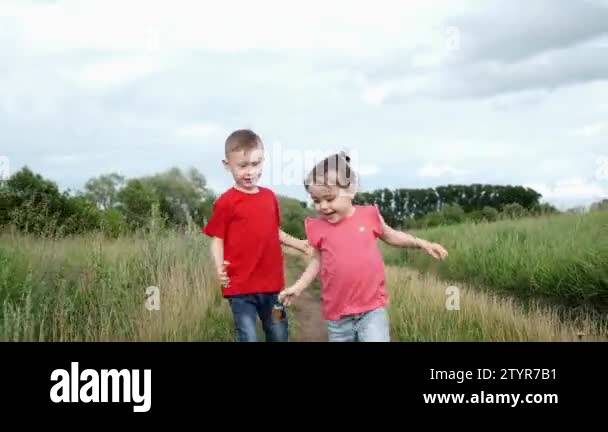 Boy, girl playing catch-up. brother sister running holding hands. run ...