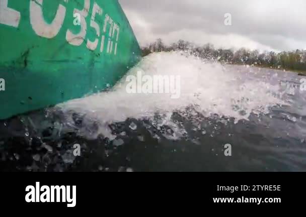 Traditional boat rushing through the water. Shooting from the water ...