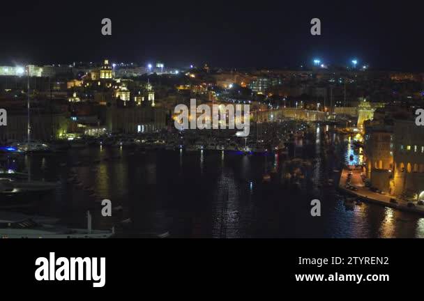 Panoramic night view of a coast line and the downtown of Valletta ...