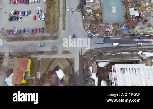Crossroads traffic in downtown with construction site and car parking ...