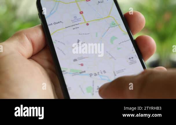 Man using navigation application with his phone and searching for journey roads to popular ...