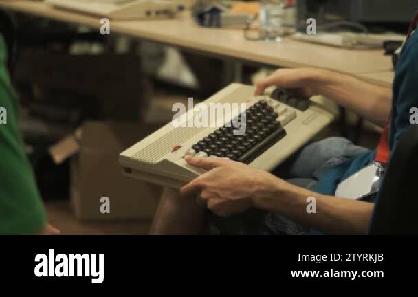 Camera slide next to people holding old computer with keyboard and ...