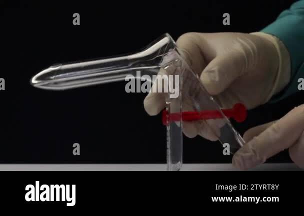 A Doctor In Rubber Gloves Shows A One Time Gynecological Mirror
