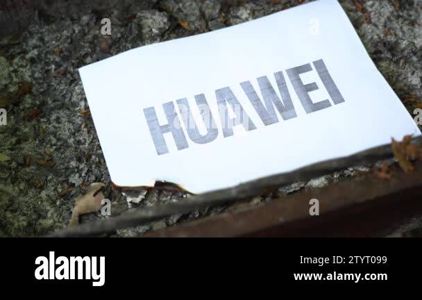 The inscription Huawei on a white A4 size sheet in the ash. The paper ...