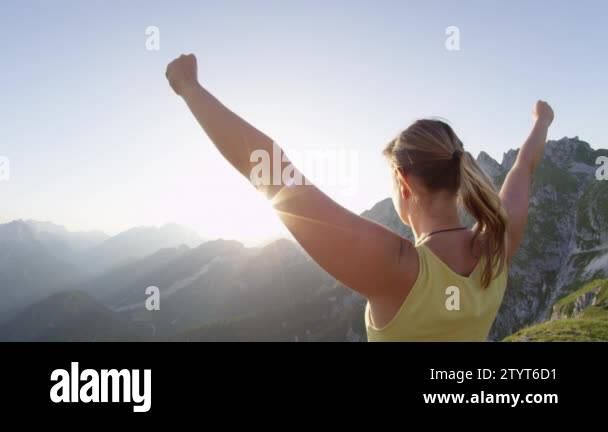 CLOSE UP LENS FLARE: Happy young hiker enjoying the breathtaking view ...