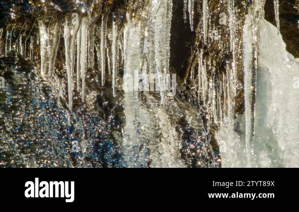 Close-up of Ice Stalactites and Icicles Melting from Mountain Stone ...