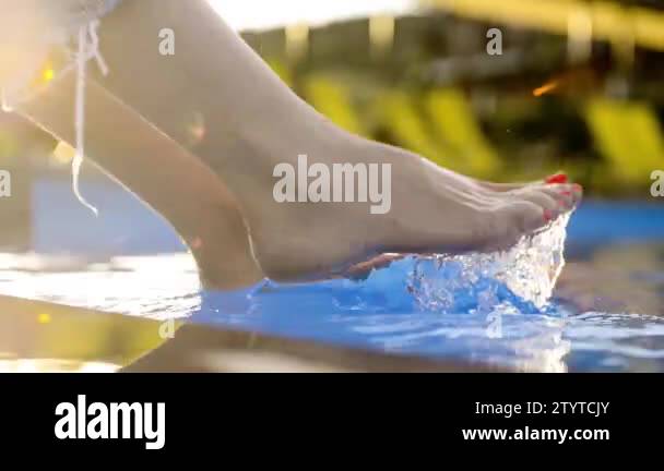 close-up footage of female feet splashing water in swimming pool Stock ...
