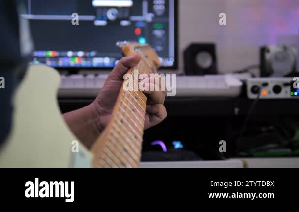 Musician artist playing guitar to record in sound mixing studio process ...